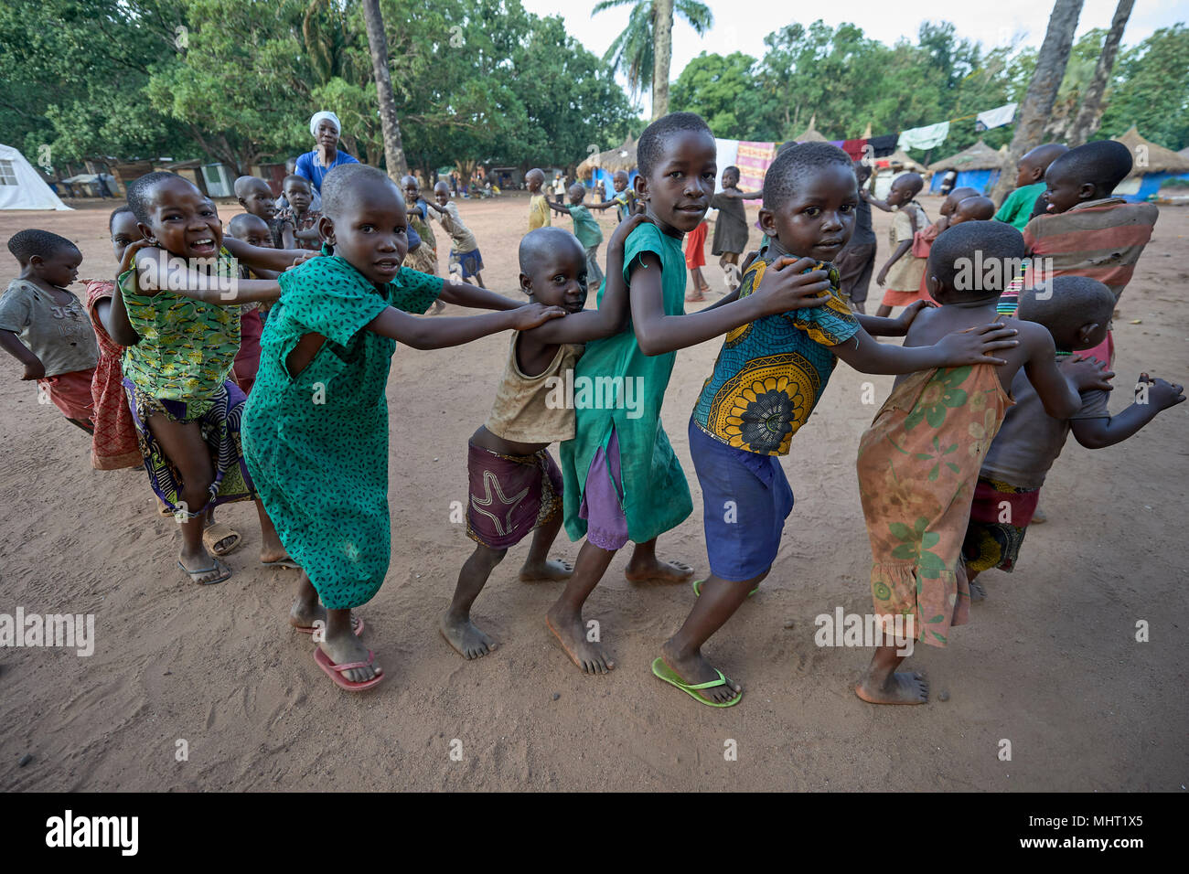 Children who have been displaced by armed conflict at play in a camp ...