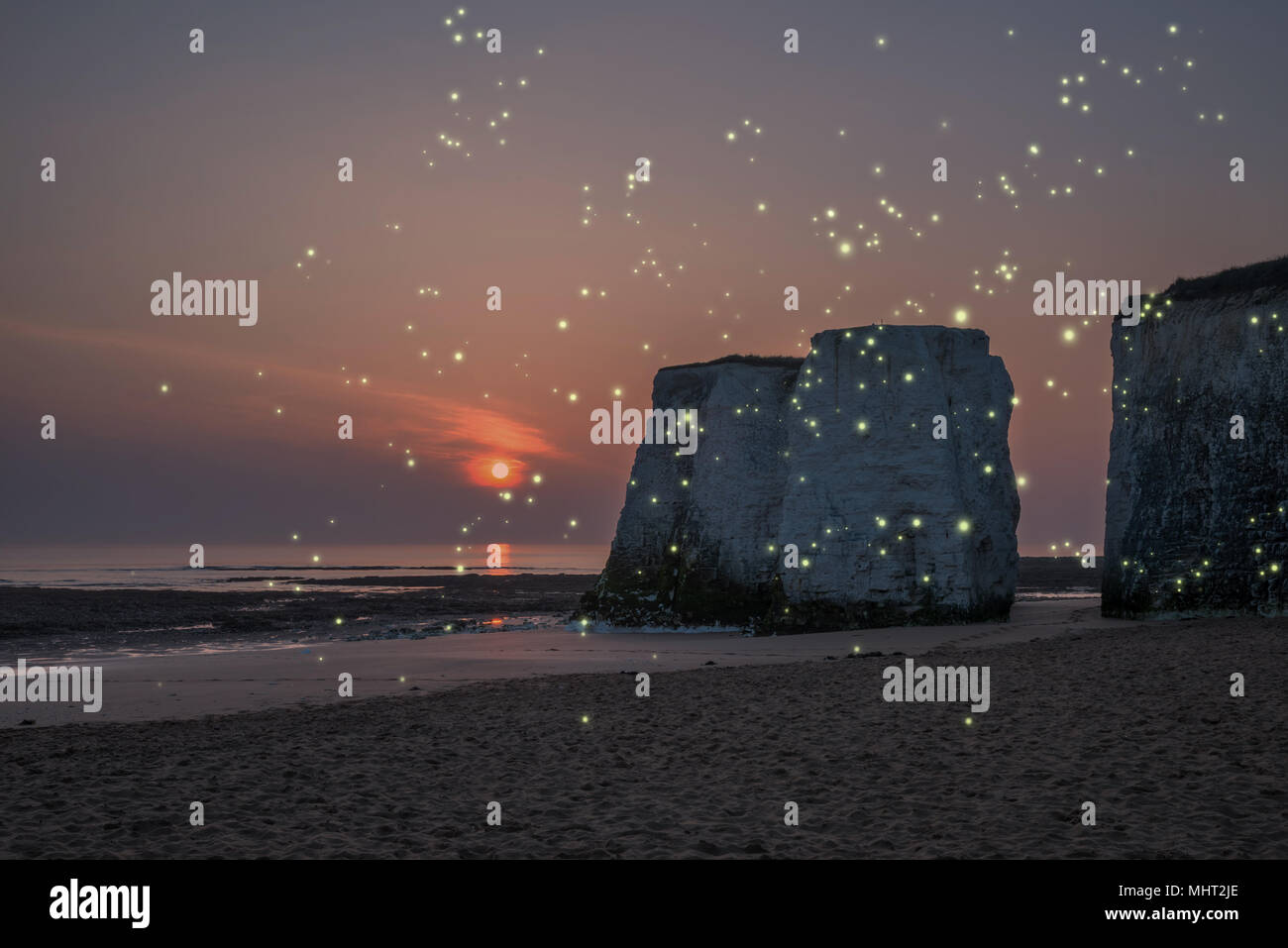 Beautiful colorful sunset over rock stacks on beach landscape with ...