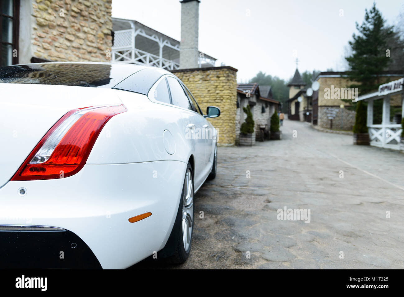 White car in a village Stock Photo - Alamy