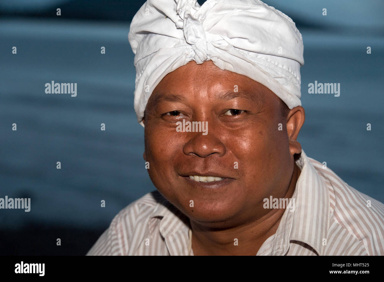 BALI, INDONESIA - AUGUST 12, 2016 - Balinese monk and worshipper with ...