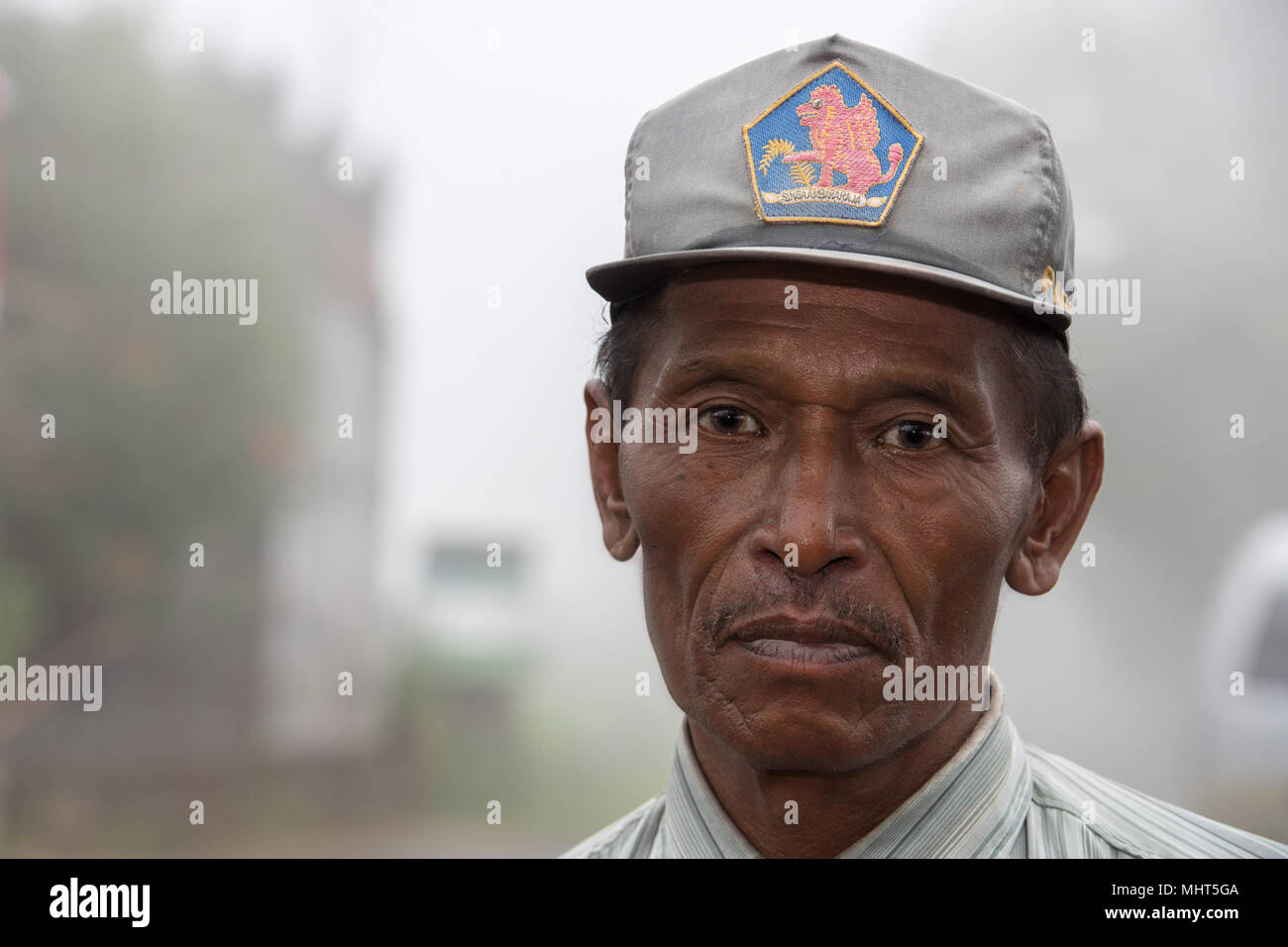 BALI, INDONESIA - AUGUST 12, 2016 - Balinese monk and worshipper with ...