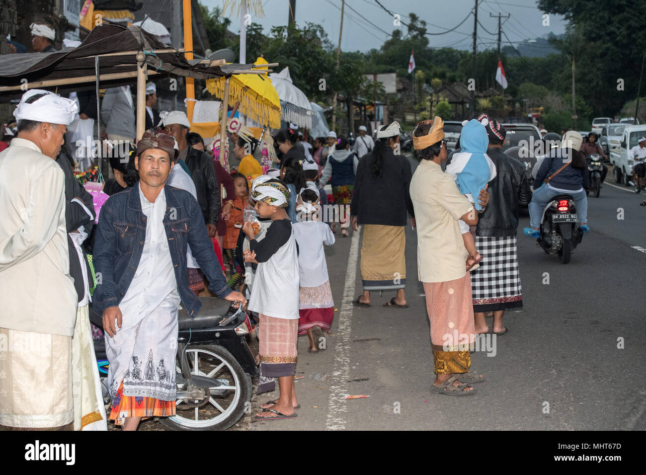 BALI, INDONESIA - AUGUST 13, 2016 - Balinese monk and worshipper with ...