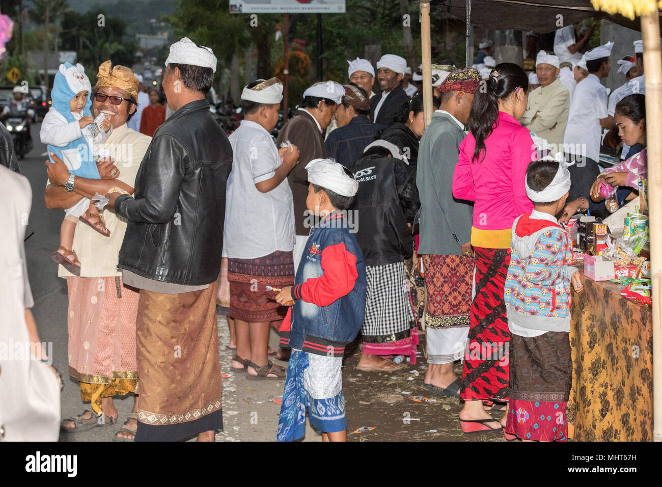BALI, INDONESIA - AUGUST 13, 2016 - Balinese monk and worshipper with ...
