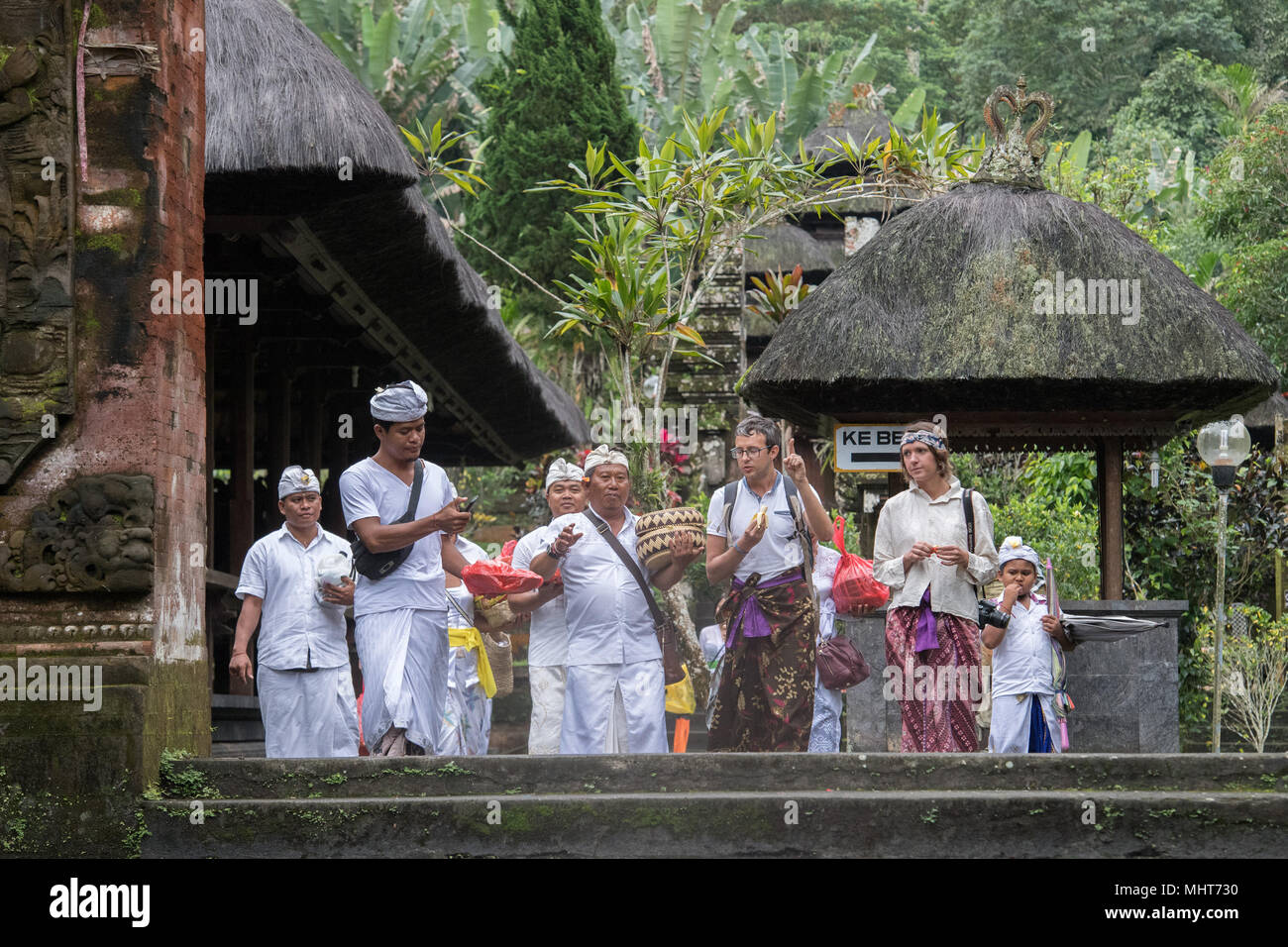 BALI, INDONESIA - AUGUST 14, 2016 - Balinese monk and worshipper with ...