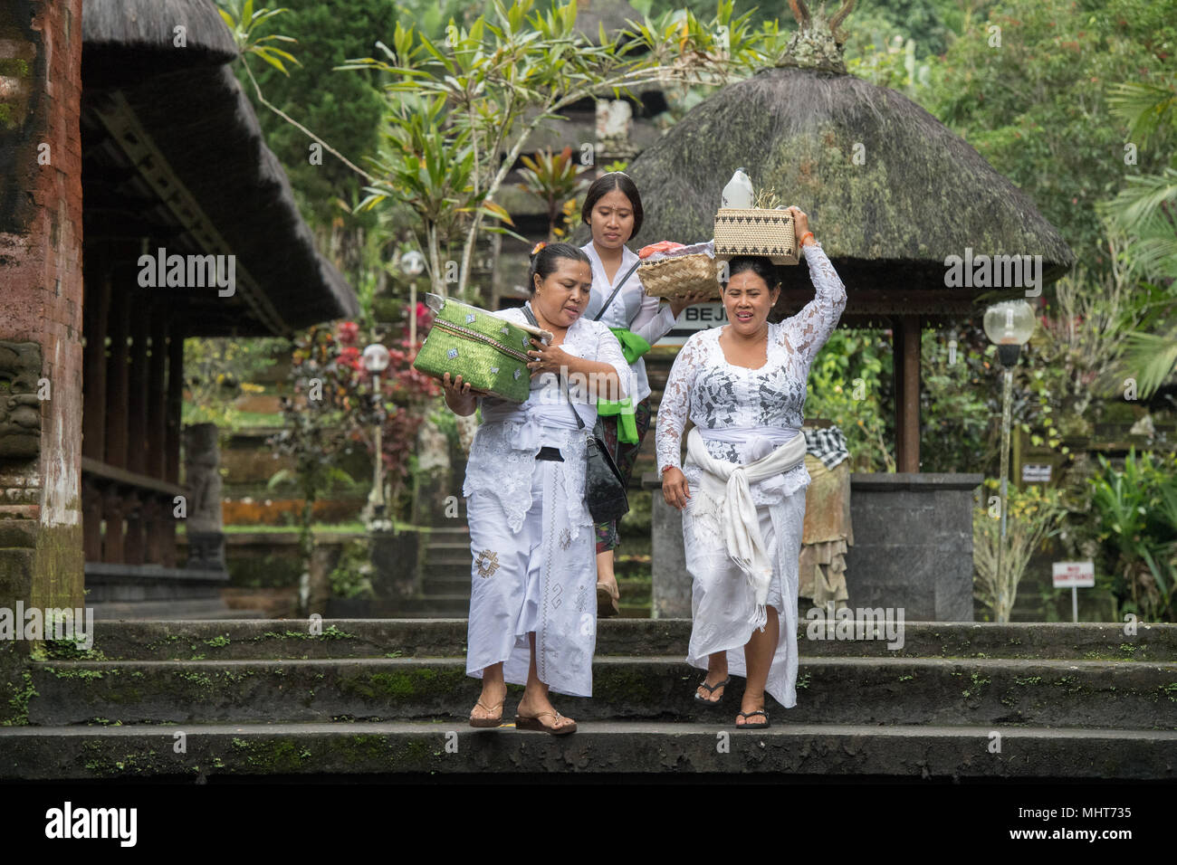 BALI, INDONESIA - AUGUST 14, 2016 - Balinese monk and worshipper with ...