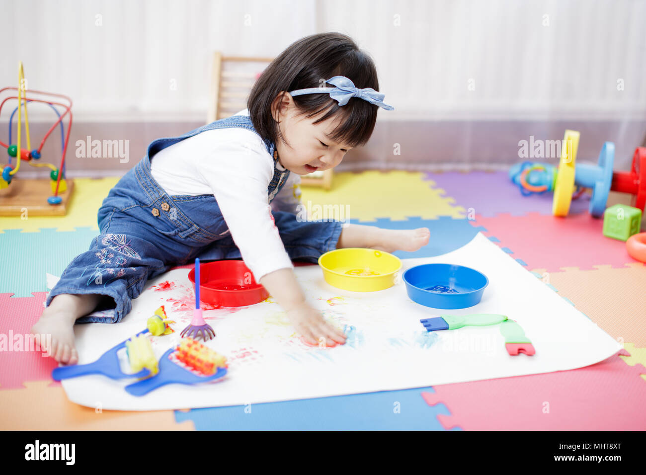 baby girl painting at home Stock Photo - Alamy