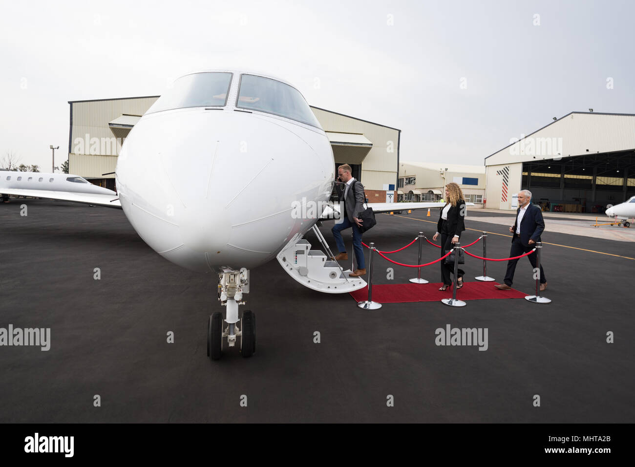 Businesspeople boarding in private jet Stock Photo - Alamy