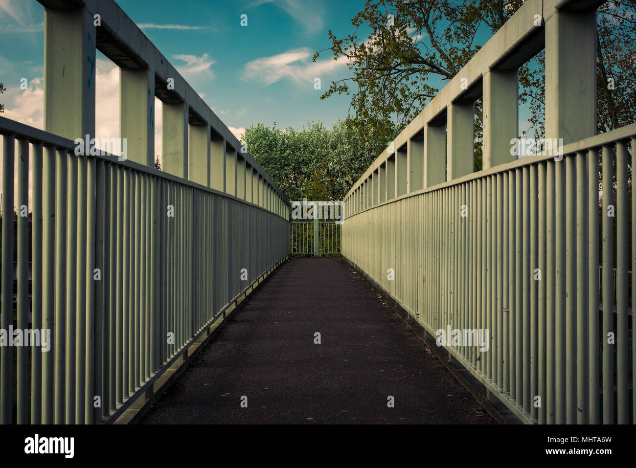 Symmetrical shot of pedestrian walkway over dual carriageway, UK Stock ...