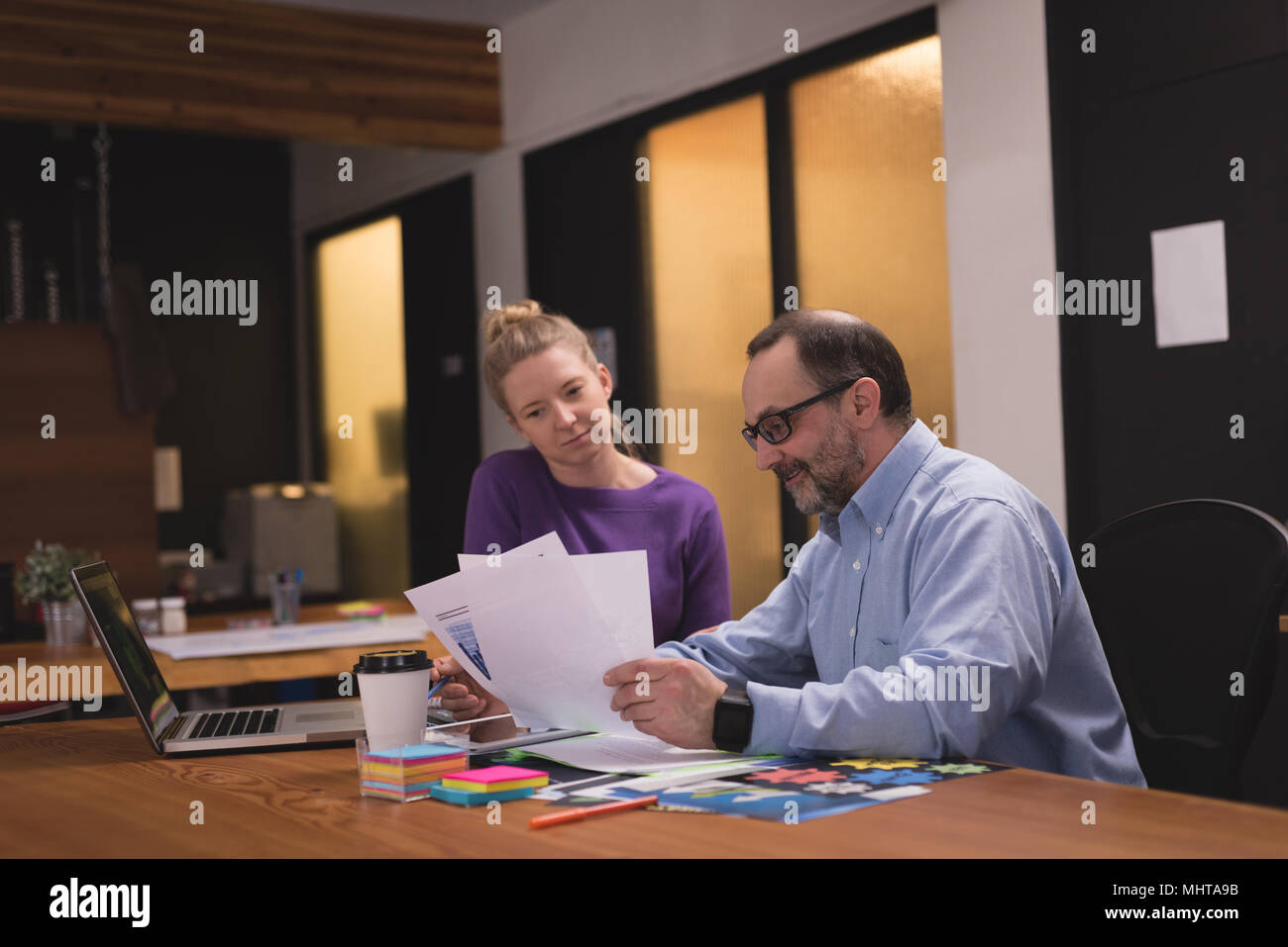 Business colleagues looking at documents Stock Photo - Alamy