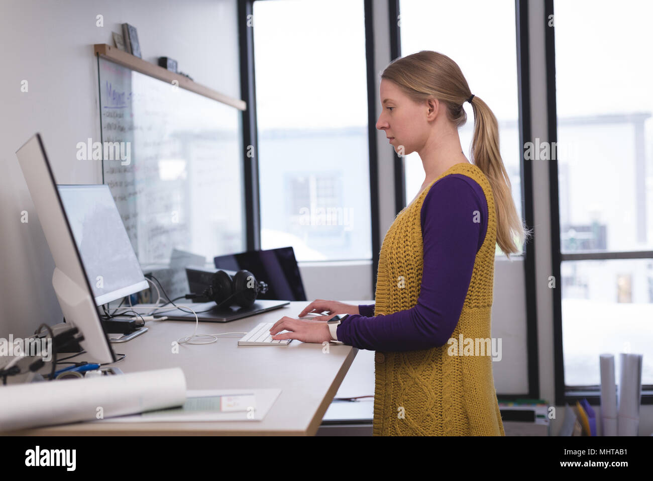 Female executive working on computer at desk Stock Photo - Alamy