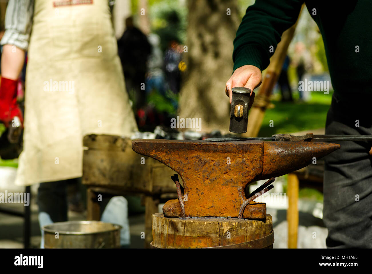 blacksmith with an anvil and a hammer Stock Photo - Alamy