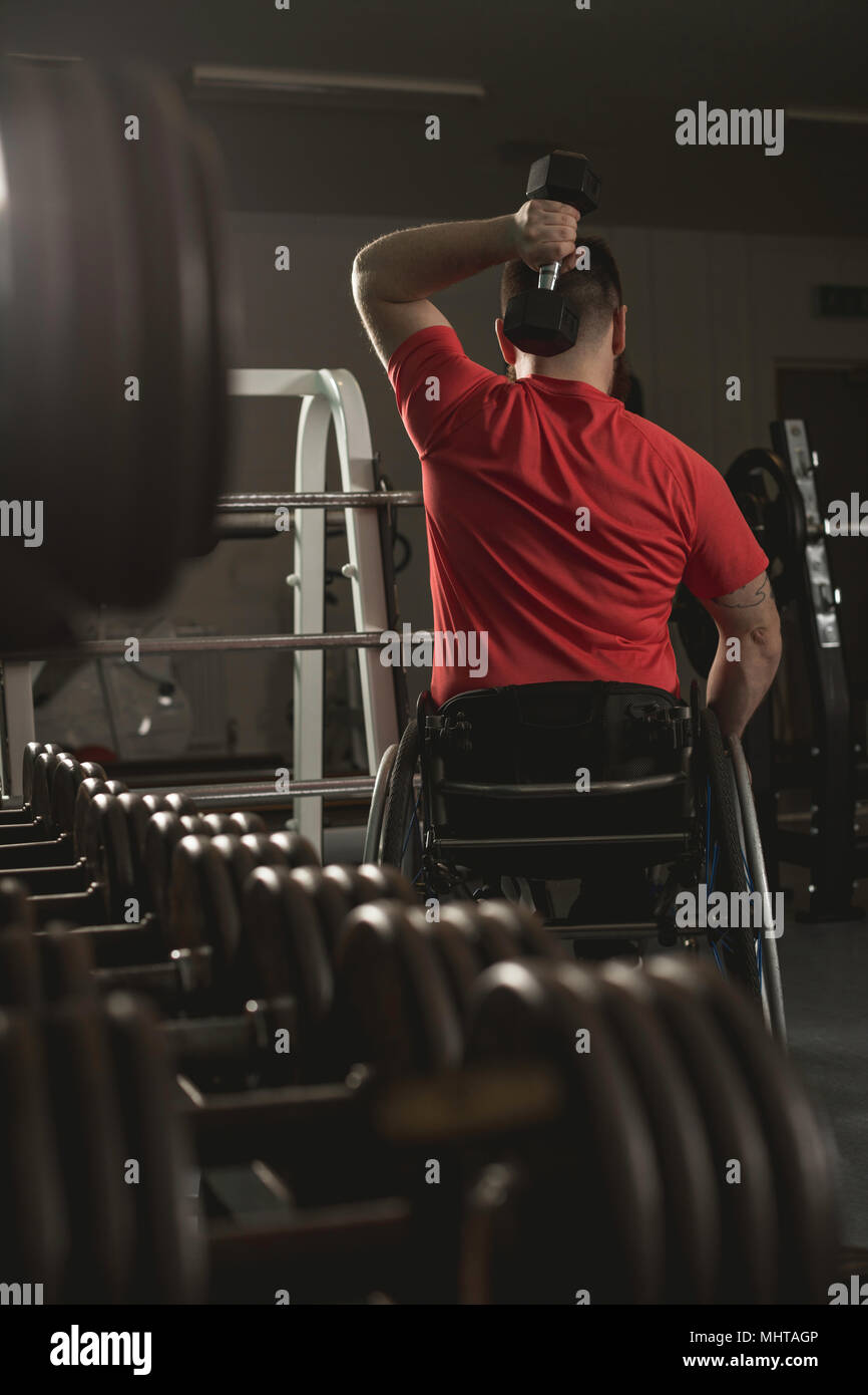 Handicapped man on wheelchair working out with dumbbell Stock Photo - Alamy