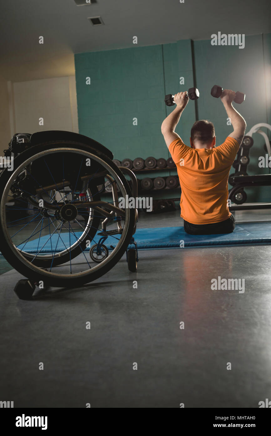 Handicapped man exercising with dumbbell Stock Photo - Alamy
