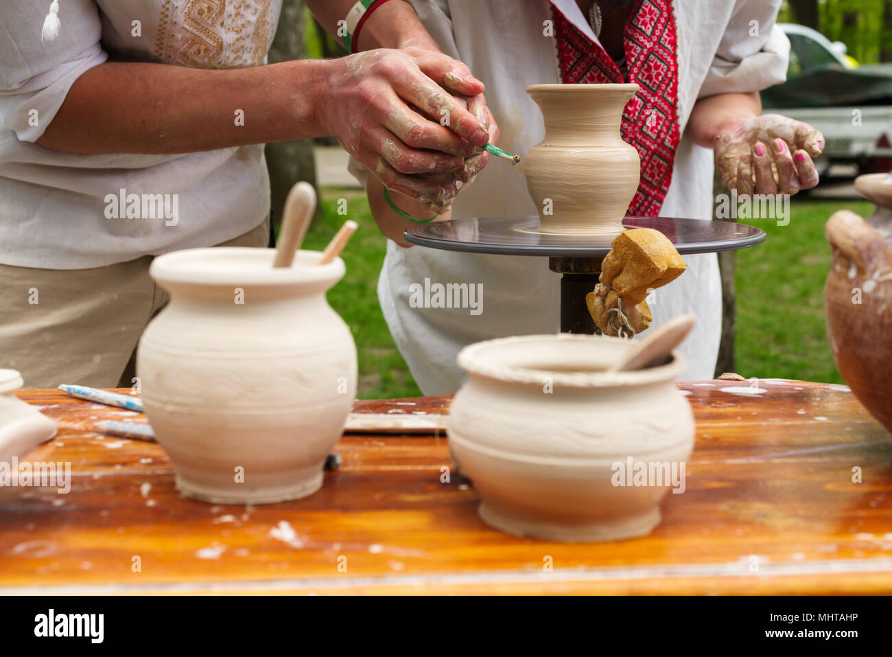 a potter shows the girl how to make a pitcher Stock Photo - Alamy