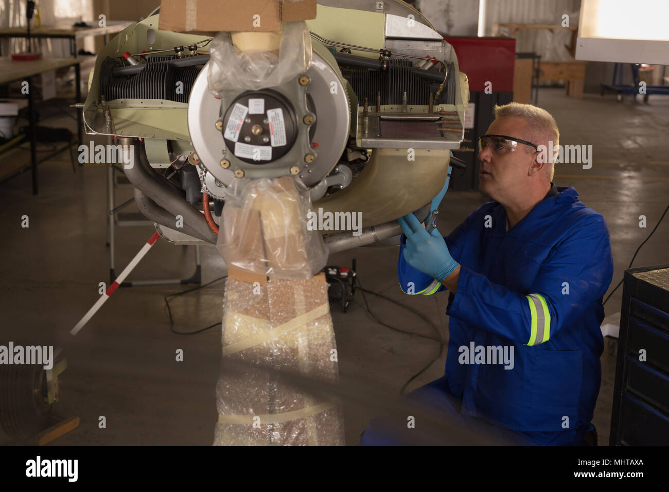 Engineer checking parts of plane Stock Photo - Alamy