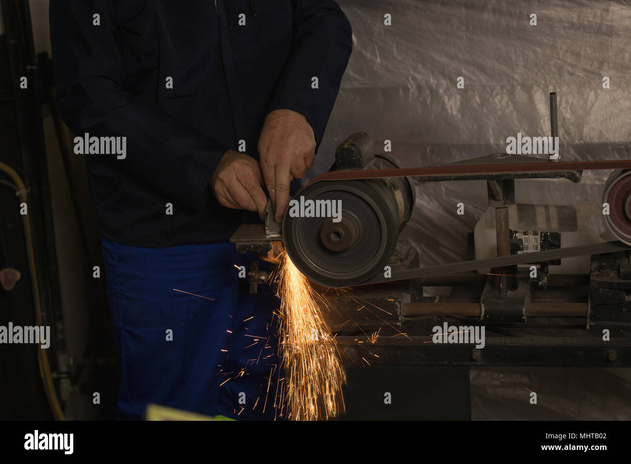 Worker shaping metal on machine Stock Photo - Alamy