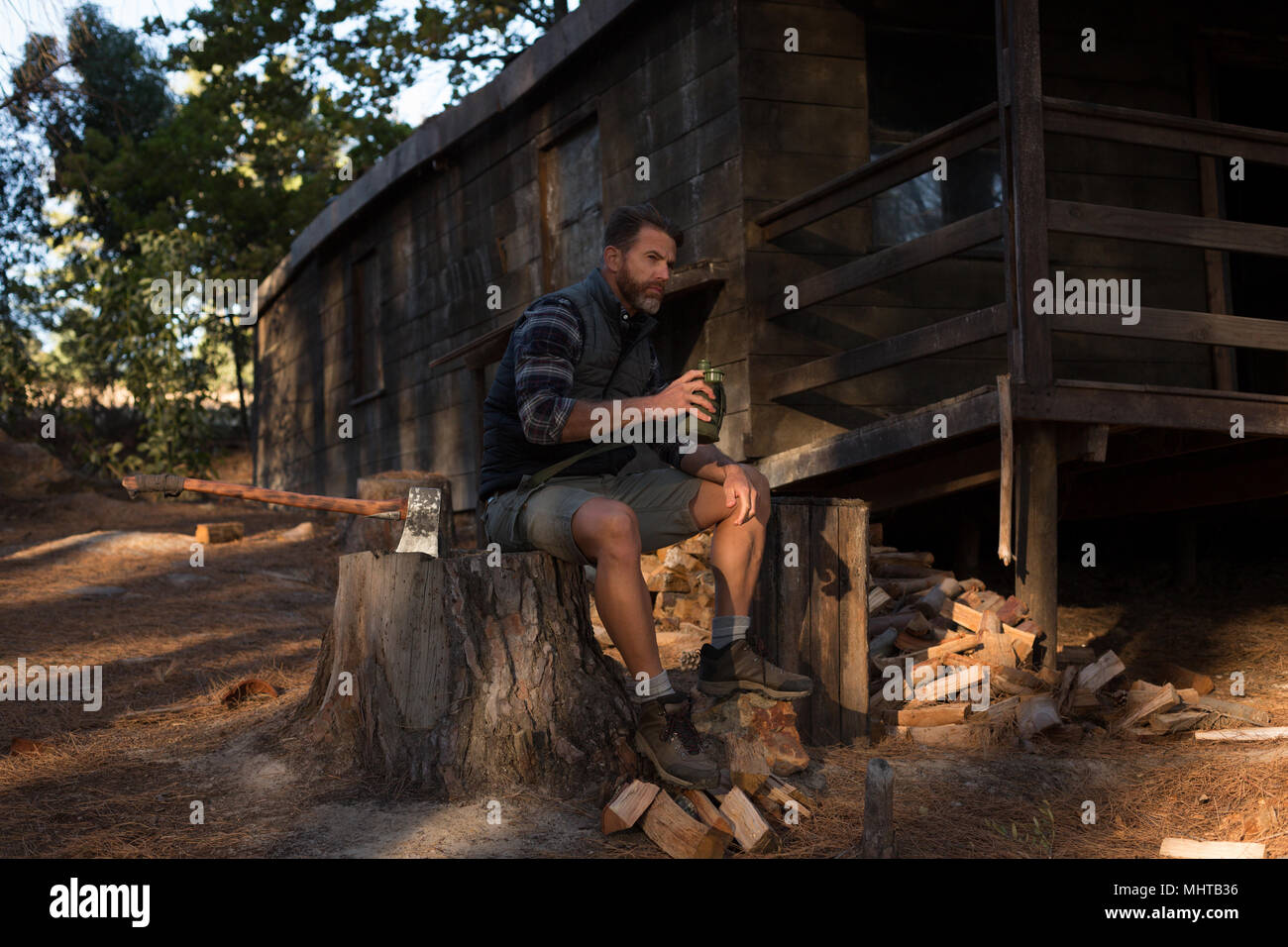 Man sitting on tree stump hi-res stock photography and images - Alamy