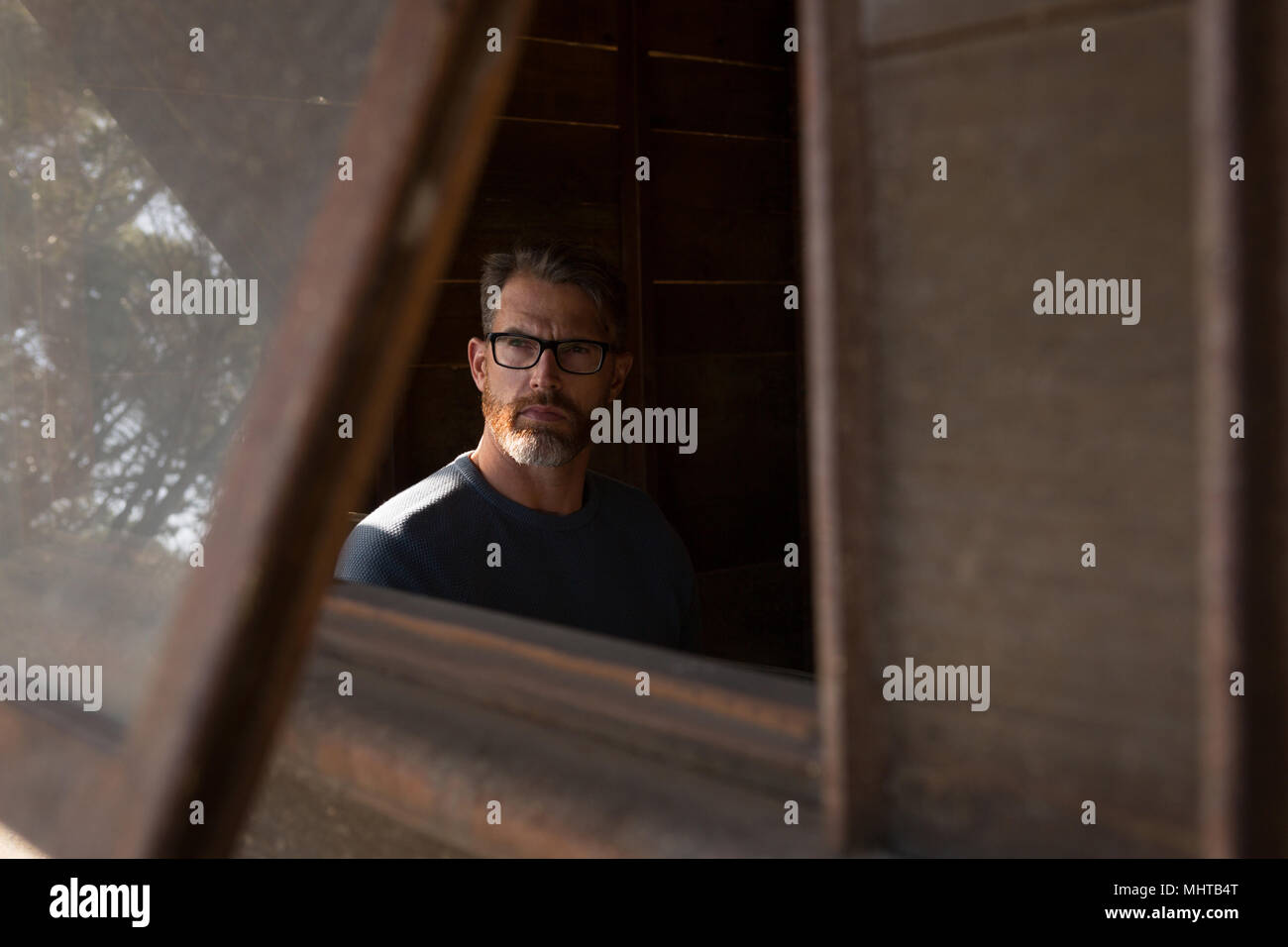 Man looking through the window Stock Photo - Alamy