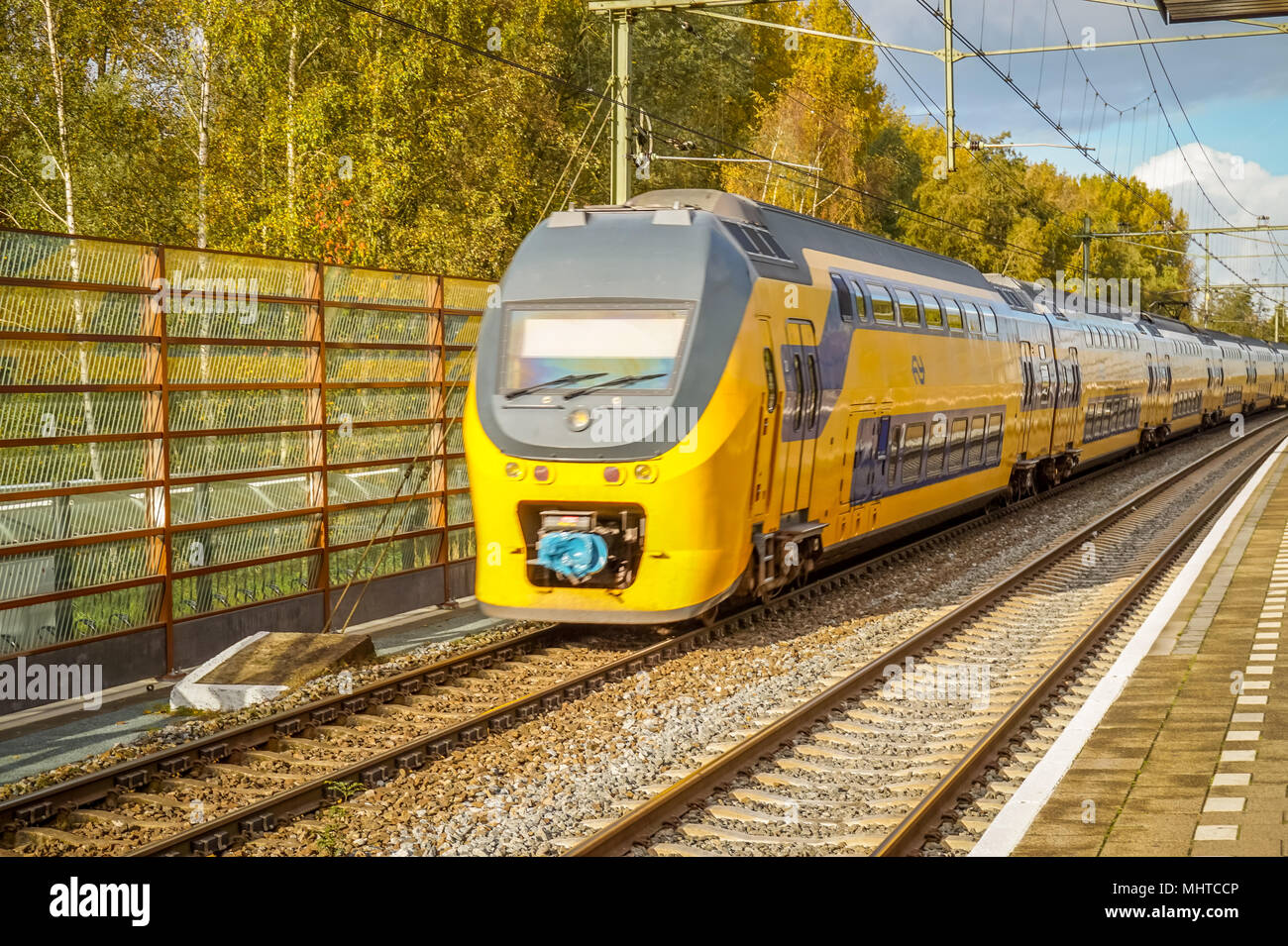 The famous modern train system coming through the rain station in the ...