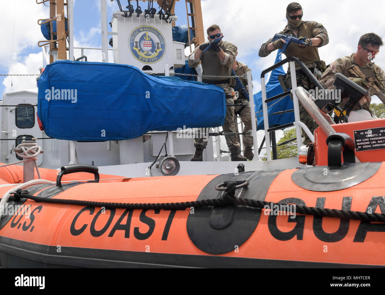 A British Royal Marine (BRM) holds security as a fellow BRMs and a ...