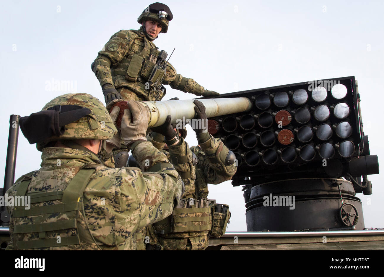 Croatian artillery soldiers assigned to Volcano Battery load a rocket ...