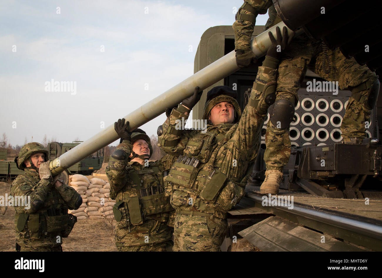 Croatian artillery soldiers assigned to Volcano Battery load a rocket ...