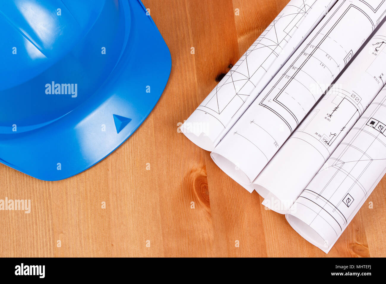 Diagrams or electrical construction drawings and protective blue helmet ...