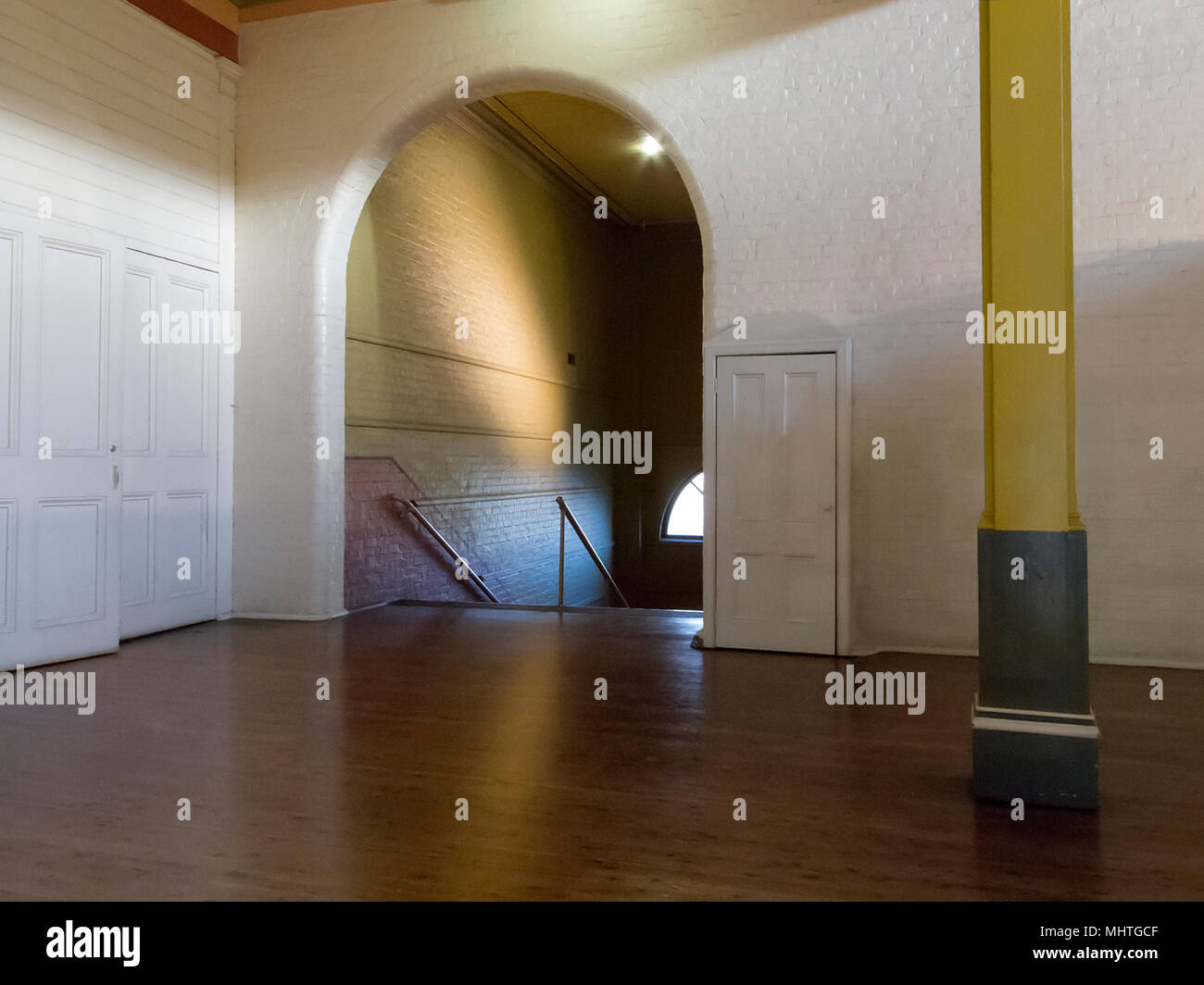 an arched stairway leading down from a large hall Stock Photo - Alamy