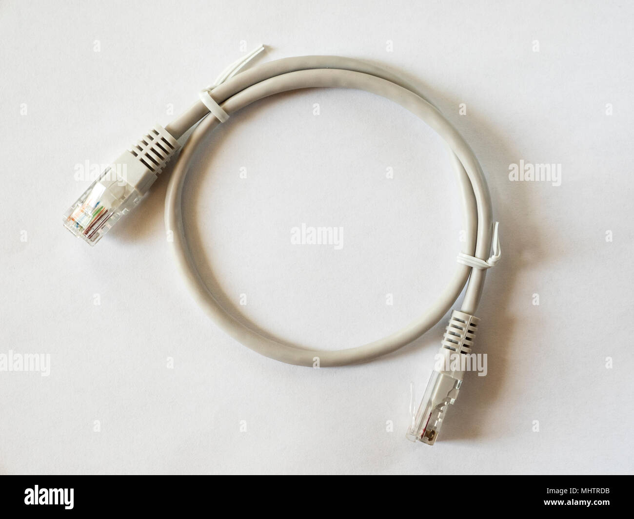 Patch cord grey network cable with molded RJ45 plug isolated on white ...