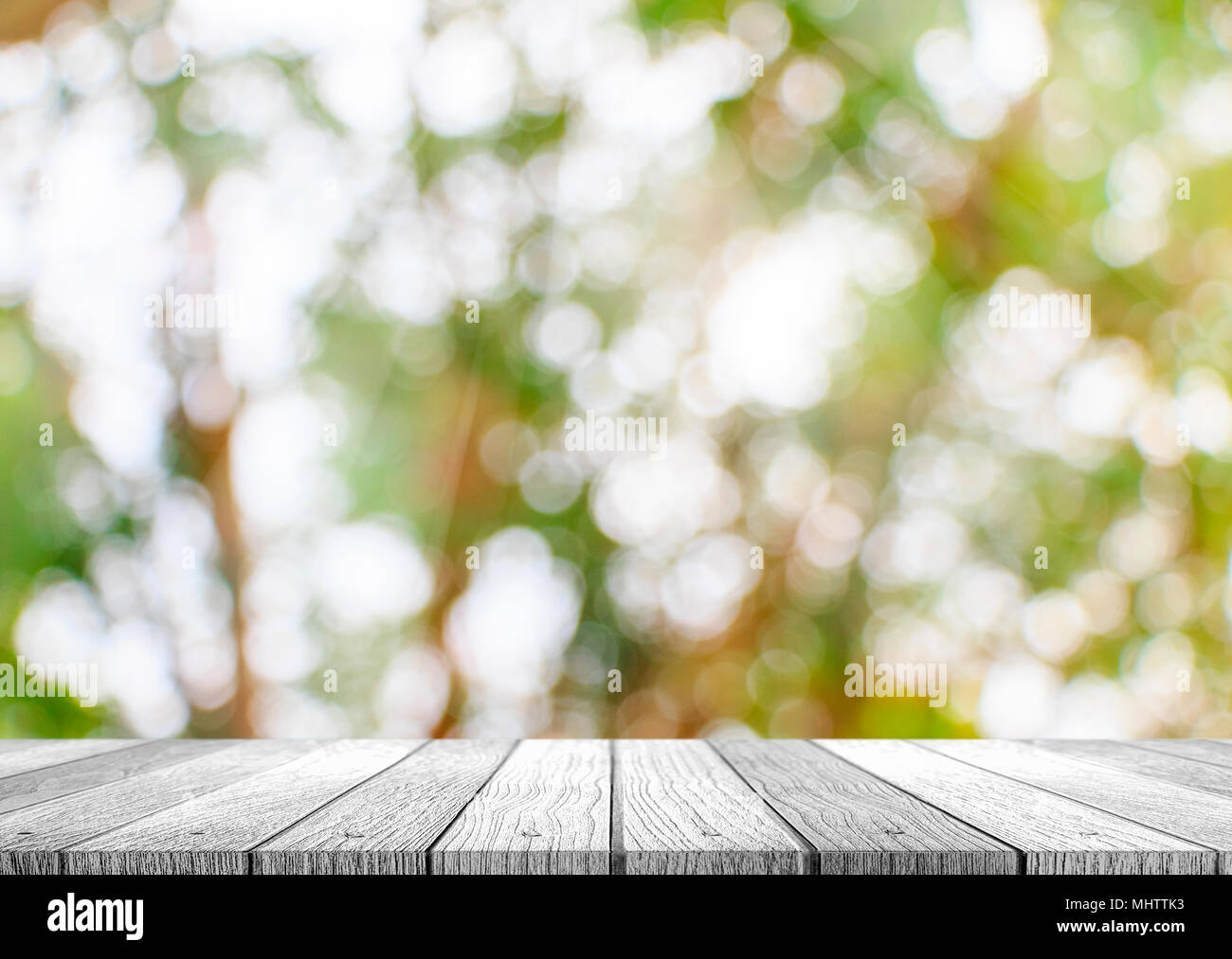 Wooden plank tabletop with fresh blurred nature green background use ...