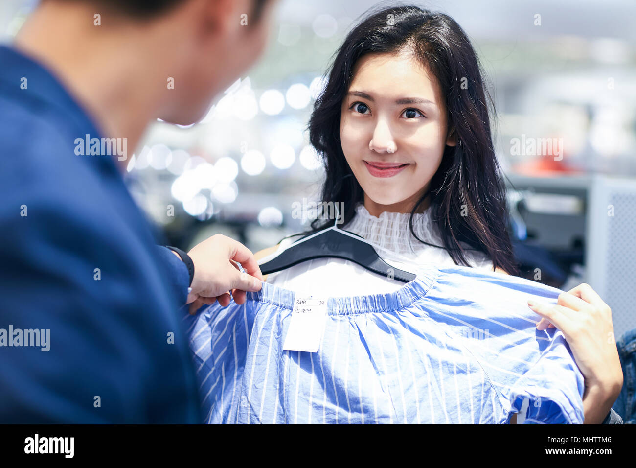 Young couples choose clothes clothing store Stock Photo - Alamy