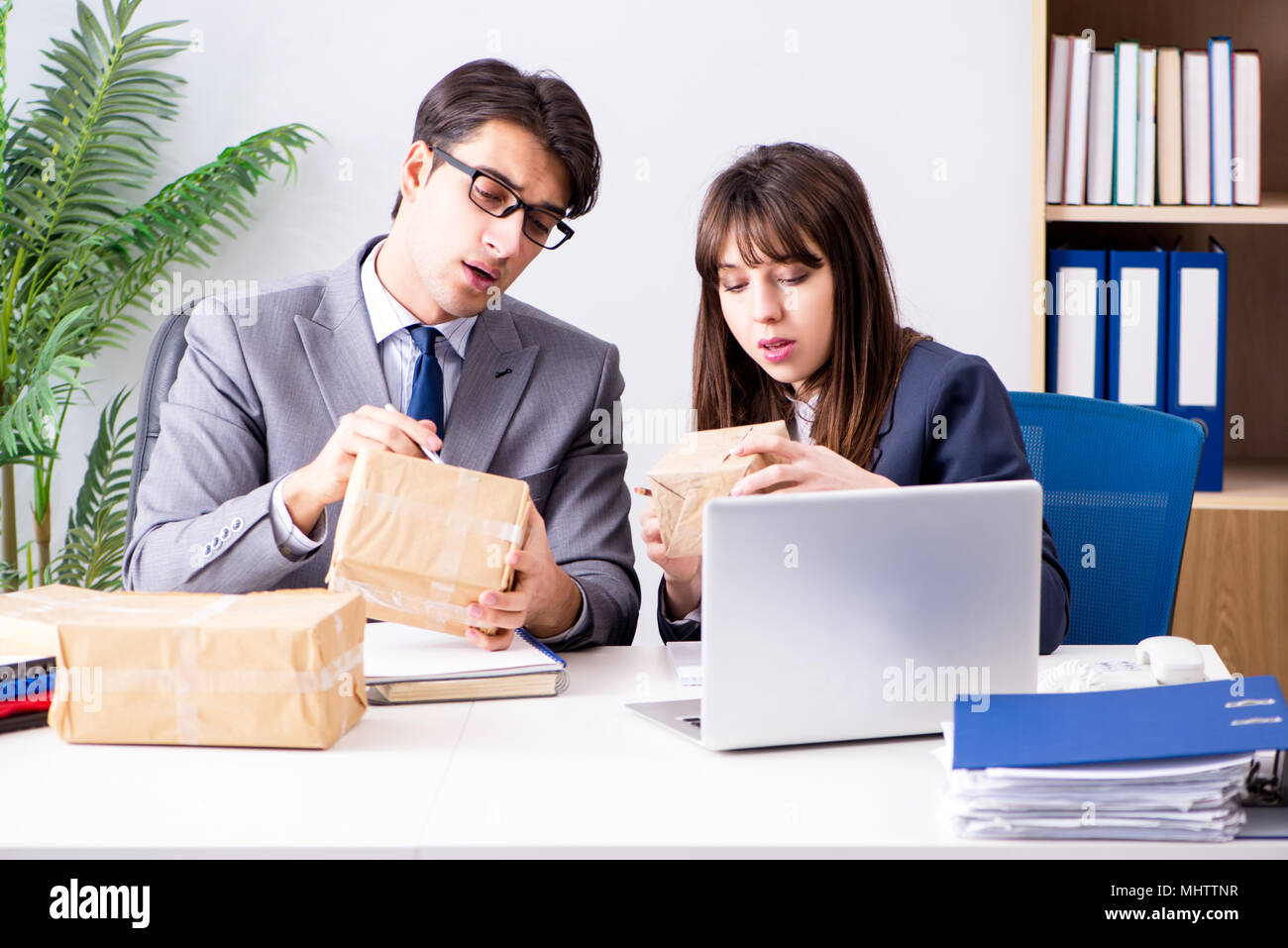 Business people receiving new mail and parcels Stock Photo - Alamy