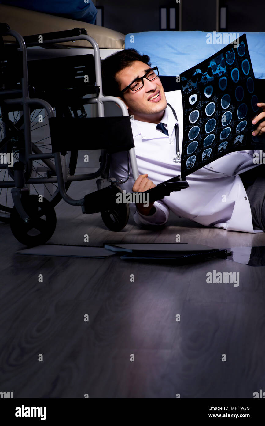 Doctor working night shift in hospital after long hours Stock Photo - Alamy