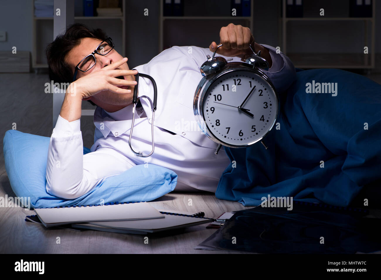 Doctor working night shift in hospital after long hours Stock Photo - Alamy