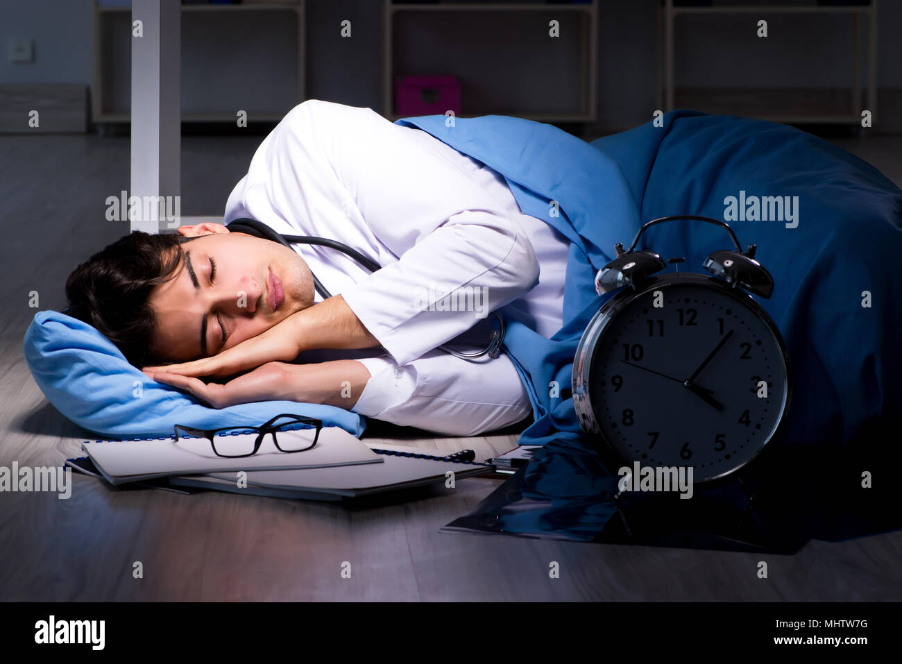 Doctor working night shift in hospital after long hours Stock Photo - Alamy