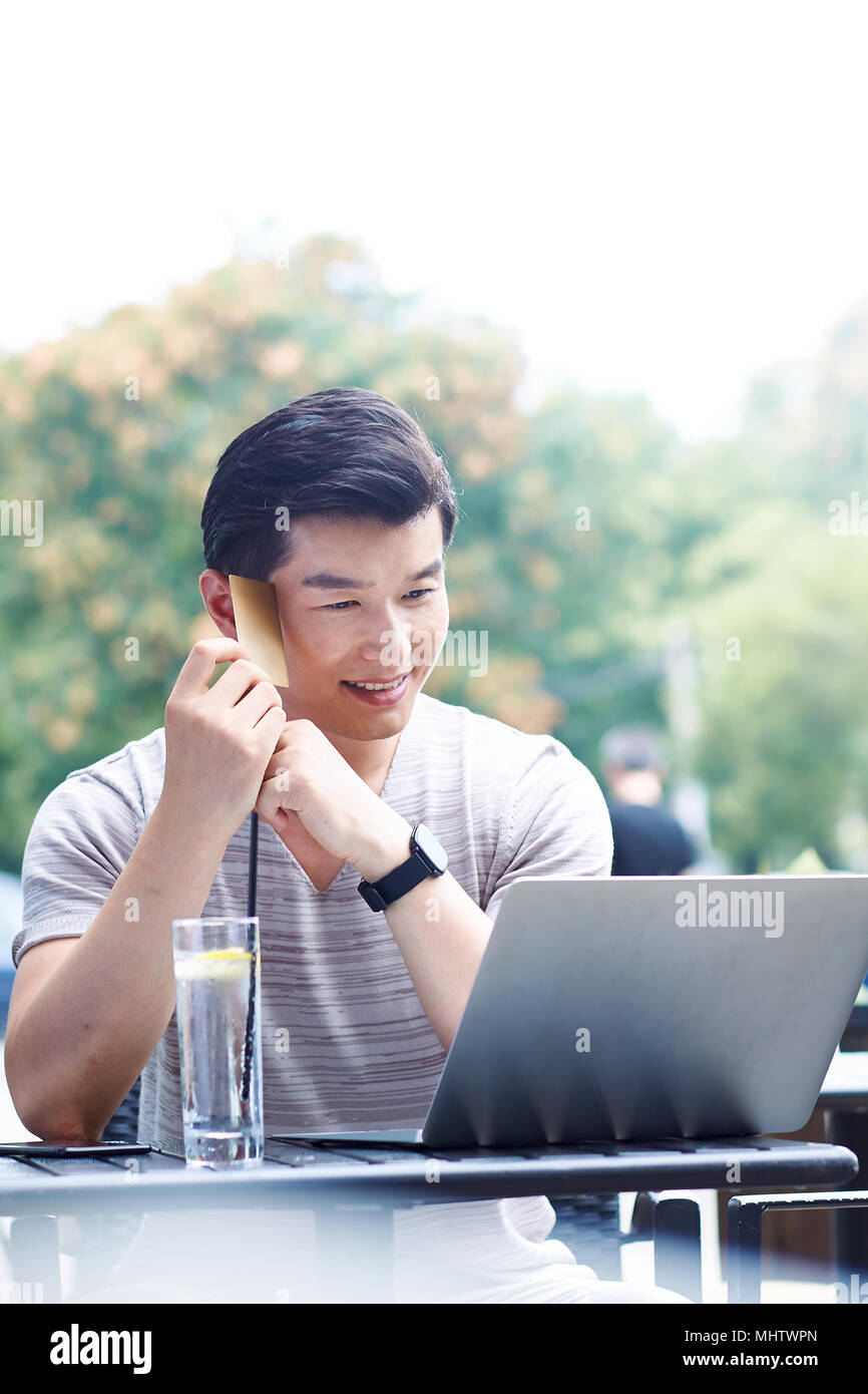 Young men online shopping Stock Photo - Alamy
