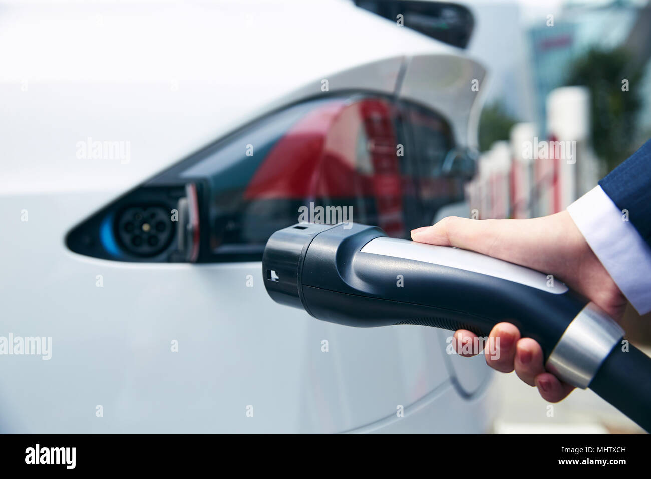 Young women to recharge electric cars Stock Photo - Alamy
