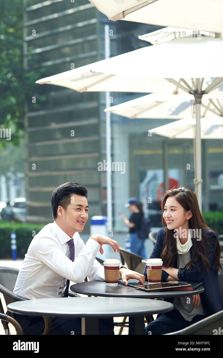Young couples in outdoor drinking coffee Stock Photo - Alamy