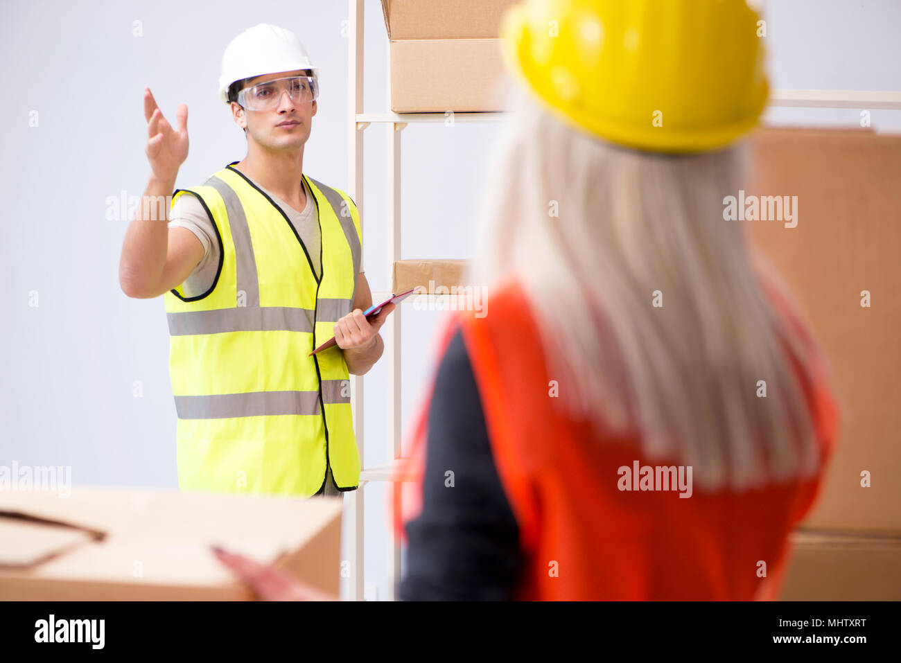 Delivery contractor delivering boxes to office Stock Photo - Alamy