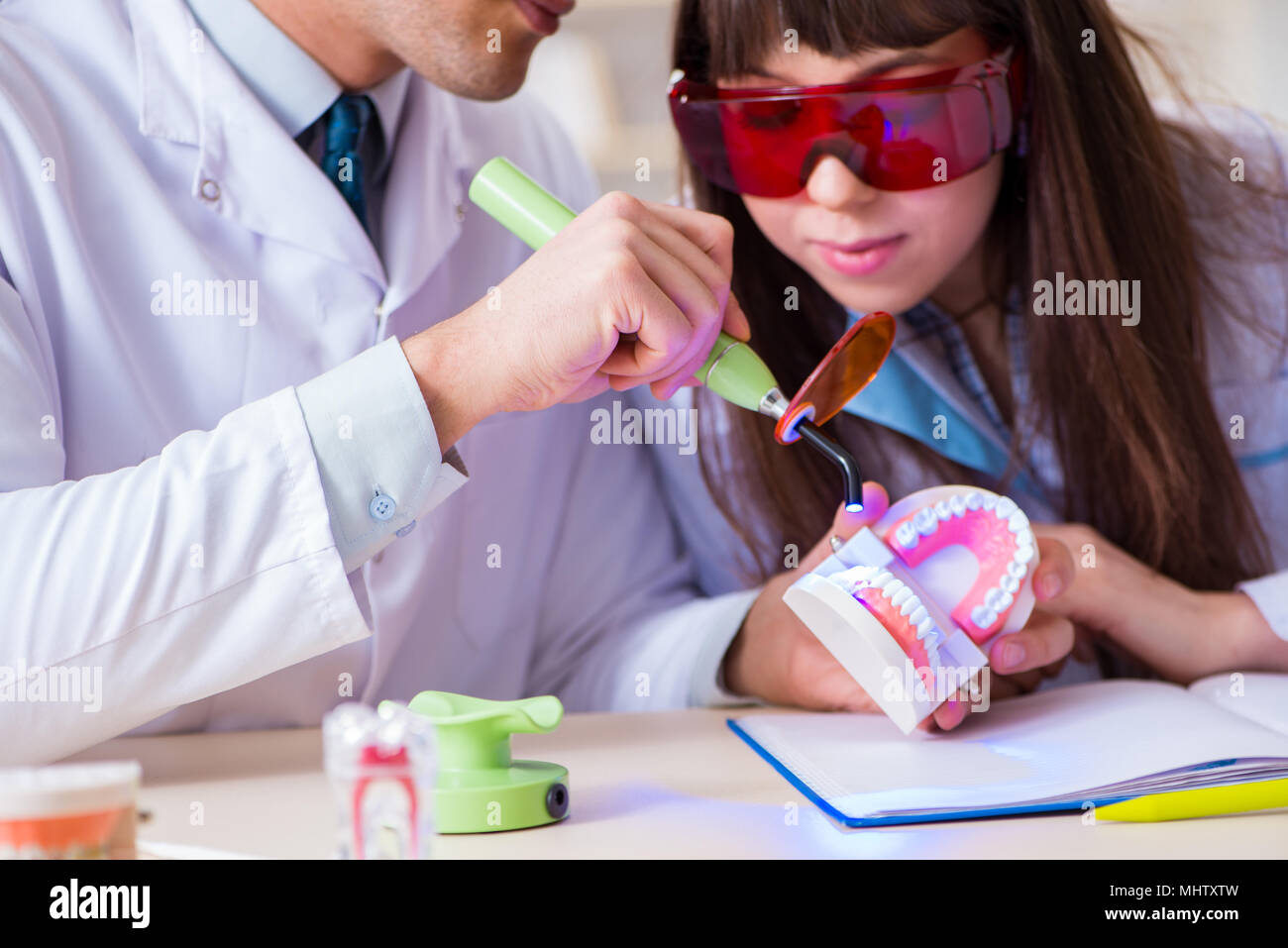 Doctor explaining to assistant how to use ultraviolet gun Stock Photo ...