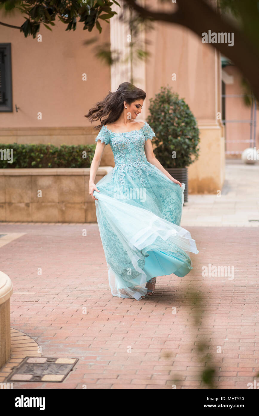 Full length of a woman twirling outdoors Stock Photo - Alamy