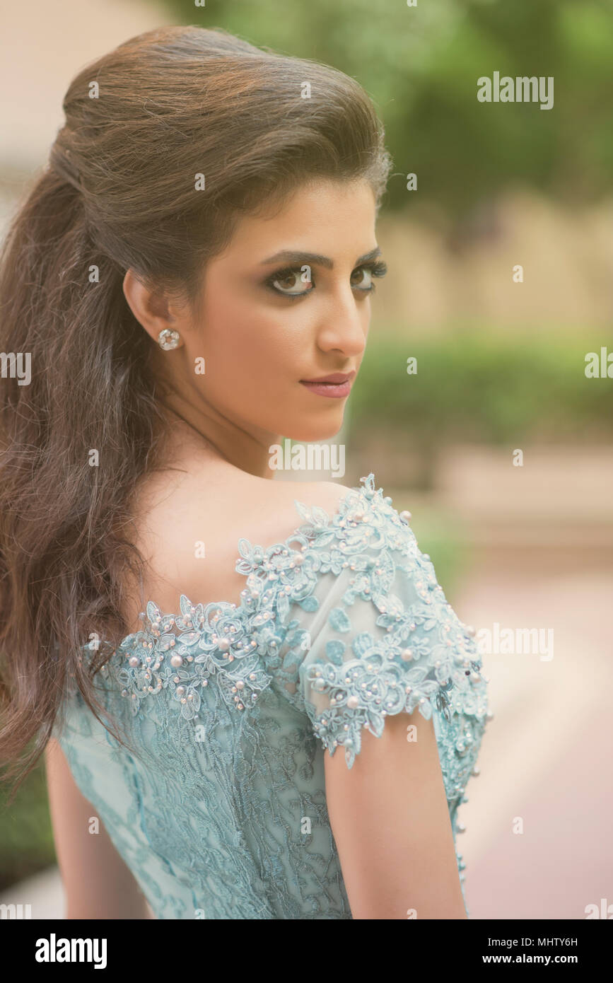 Beautiful woman looking over shoulder Stock Photo - Alamy