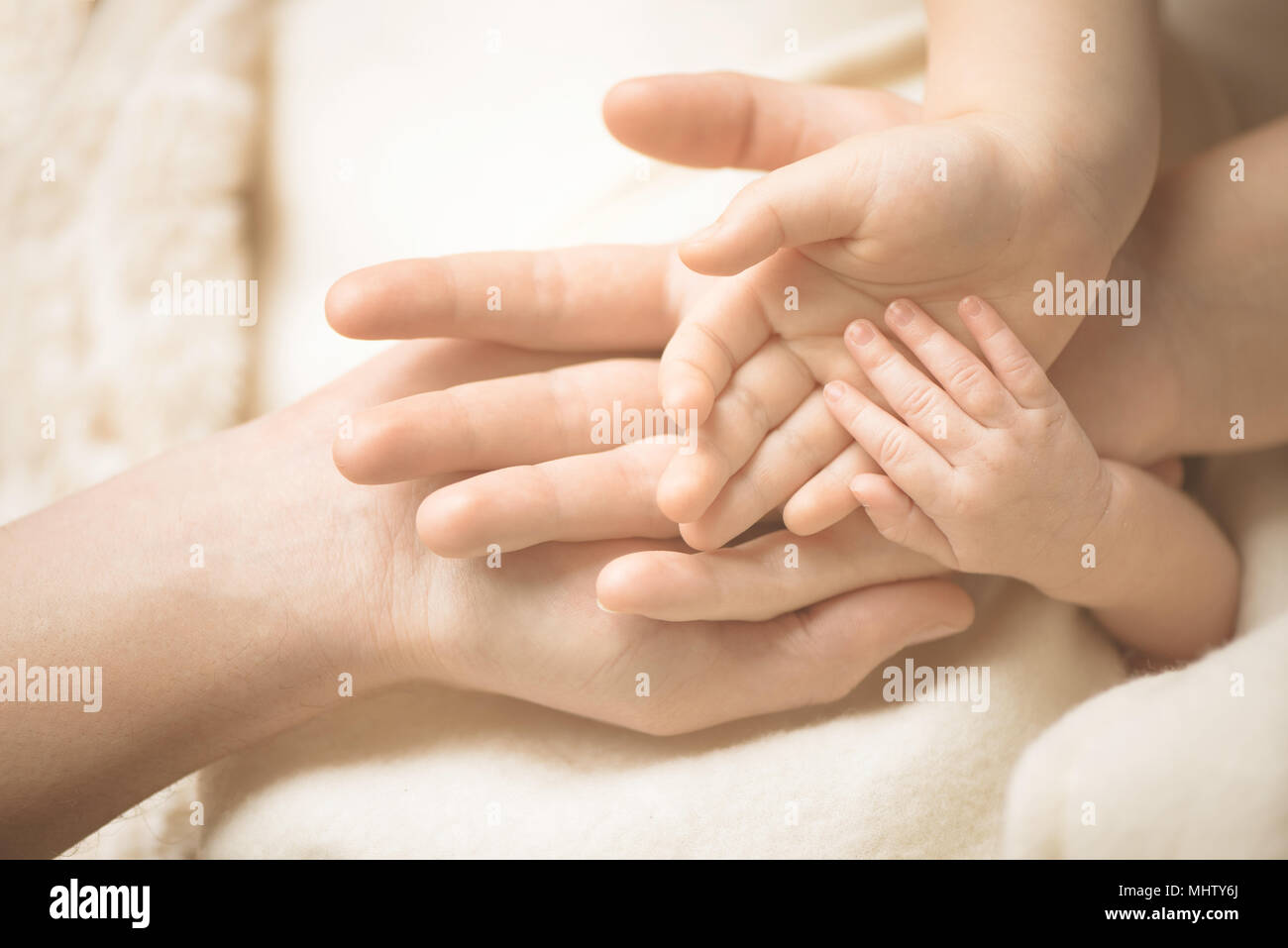Newborn child hand. Closeup of baby hand into parents hands. Family ...