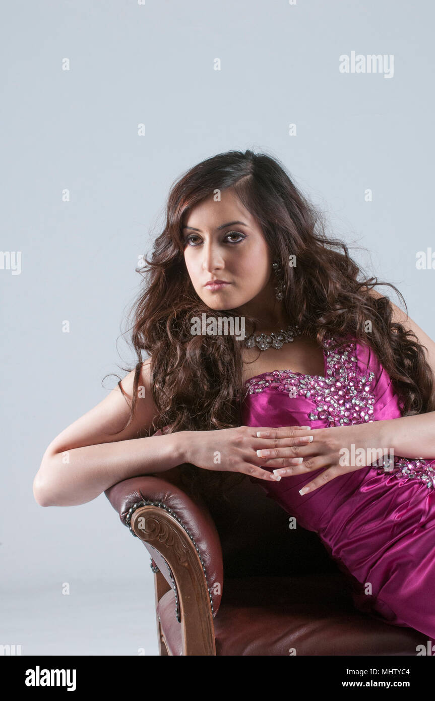 Beautiful pensive woman sat down looking away Stock Photo - Alamy