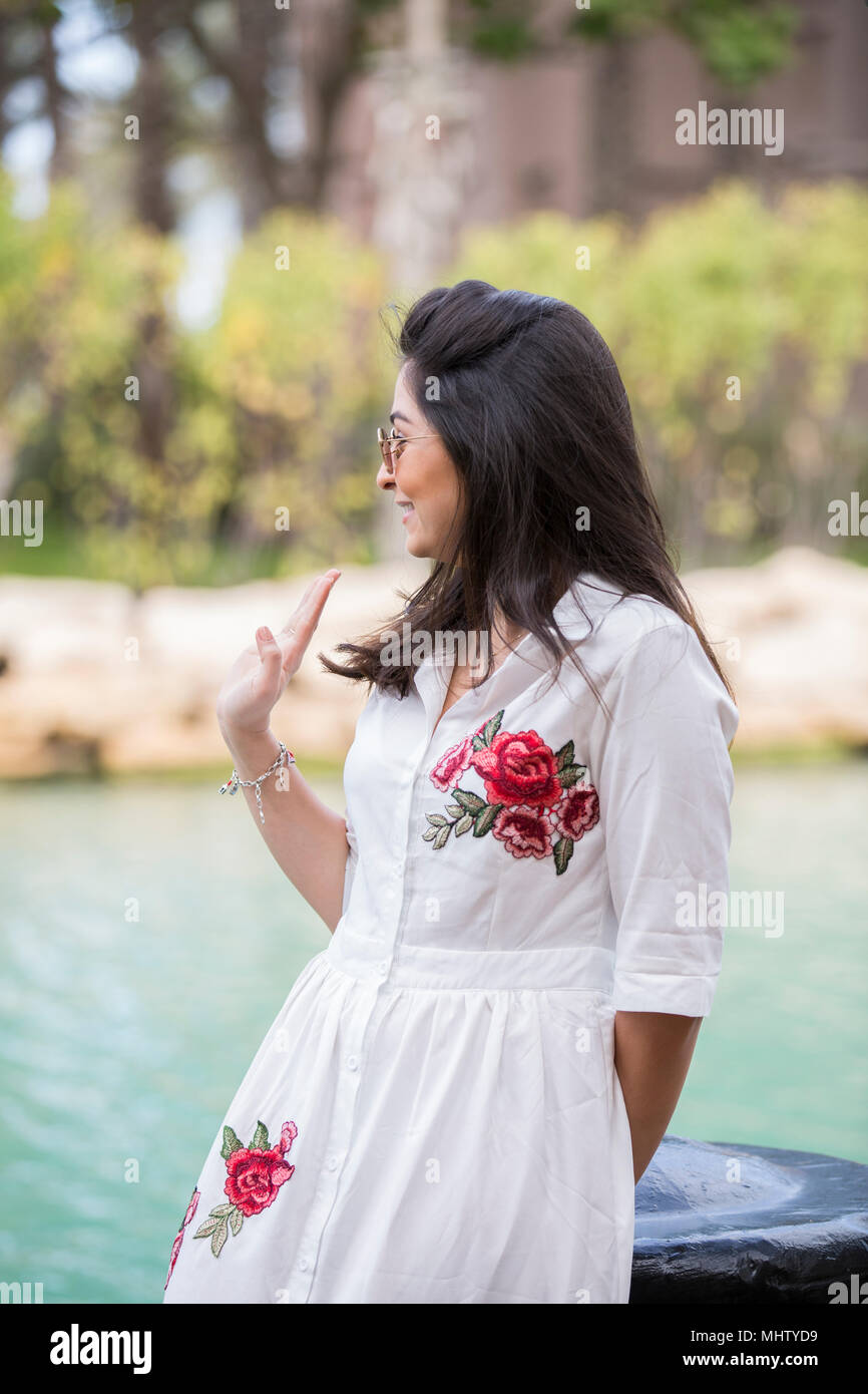Beautiful woman waving outdoors Stock Photo - Alamy