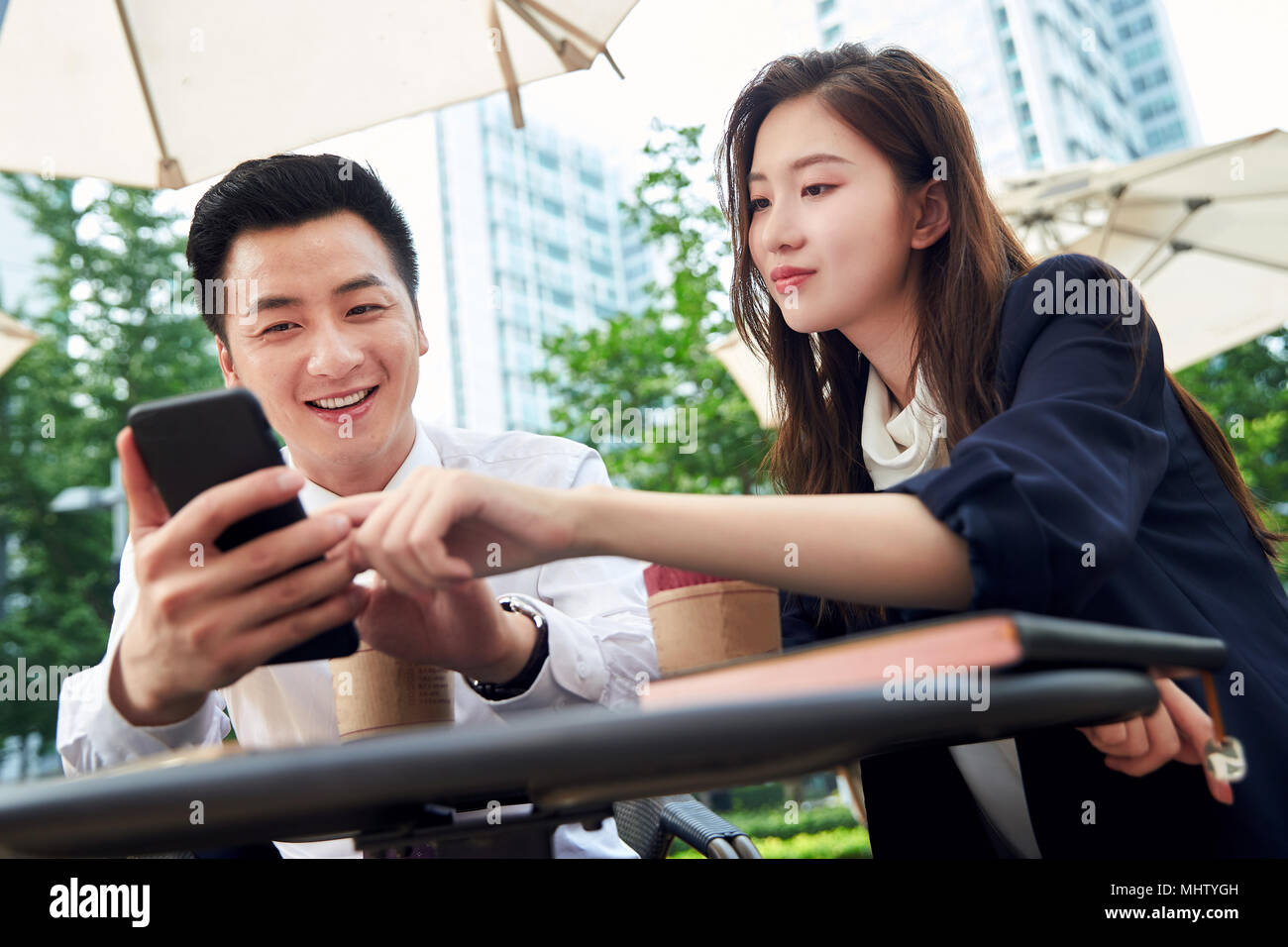 Business people in the outdoor use cellular phones Stock Photo - Alamy