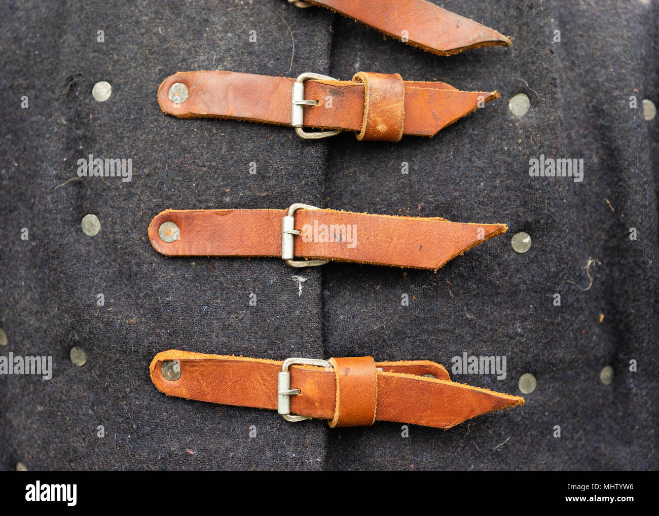 Leather fasteners or straps of a medieval knight overcoat made of the ...
