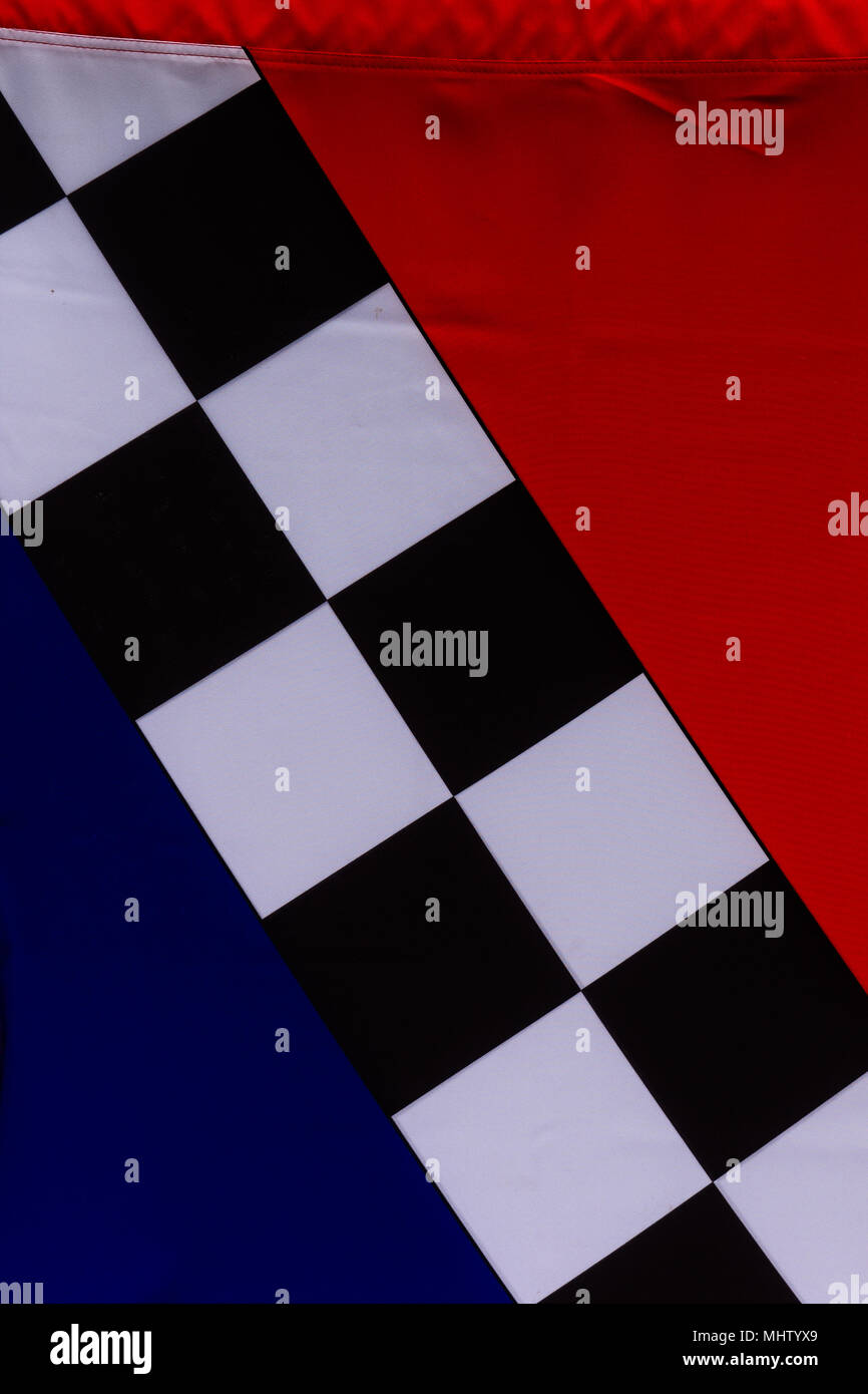 Details of a colorful medieval flag. Red and dark blue fields, diagonal ...