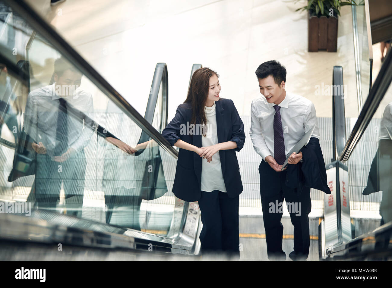 Business people talking in the elevator Stock Photo - Alamy