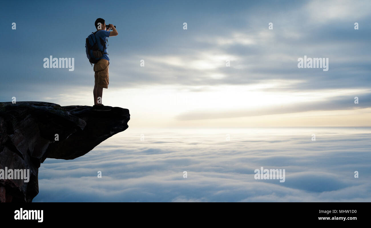 The middle-aged man standing on the cliff overlooking Stock Photo - Alamy